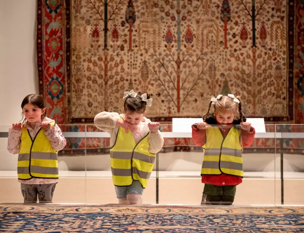 Children marveling at the Wagner Garden Carpet. Courtesy of the Burrell Collection.