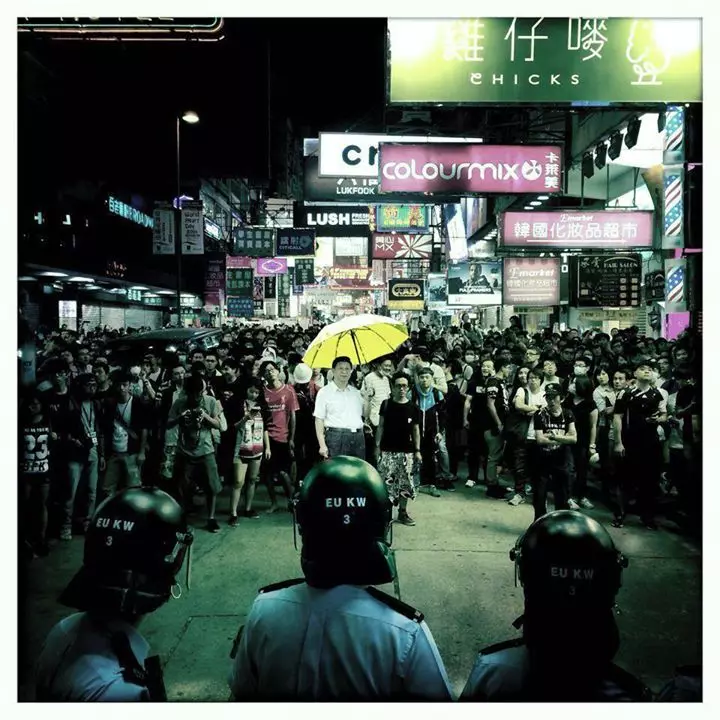 Chinese president Xi Jinping holds an umbrella in front of riot police in this Photoshopped image.