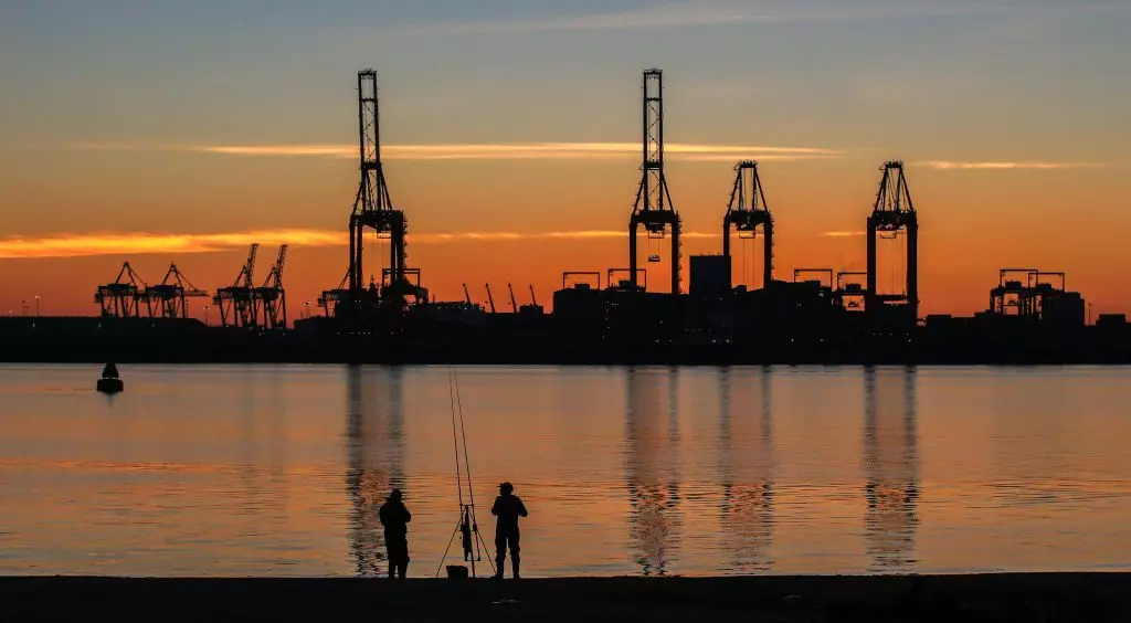 Sportfiskare fiskar på New Brighton-stranden när solen går upp över Liverpools hamn och floden Mersey. (Foto av Peter Byrne/PA Images via Getty Images)