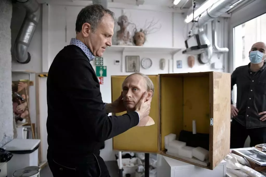 Yves Delhommeau, Musee Grevin's French Director General, packs a wax statue of Russian President Vladimir Putin before it is stored in the reserve, as a reaction to Russia's invasion of Ukraine on March 1, 2022 at the Grevin museum in Paris. Photo by Julien de Rosa/AFP via Getty Images.